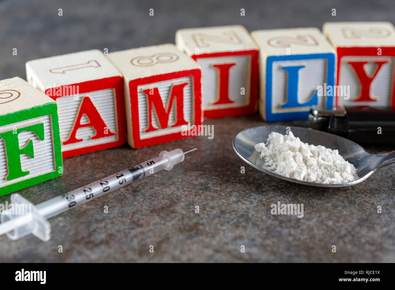 "Family" spelled out in blocks with syringe, spoon with powder, and ...