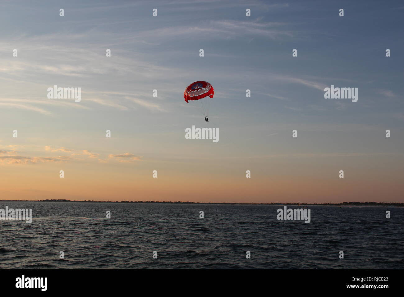Parachute skydiving over the ocean Stock Photo - Alamy