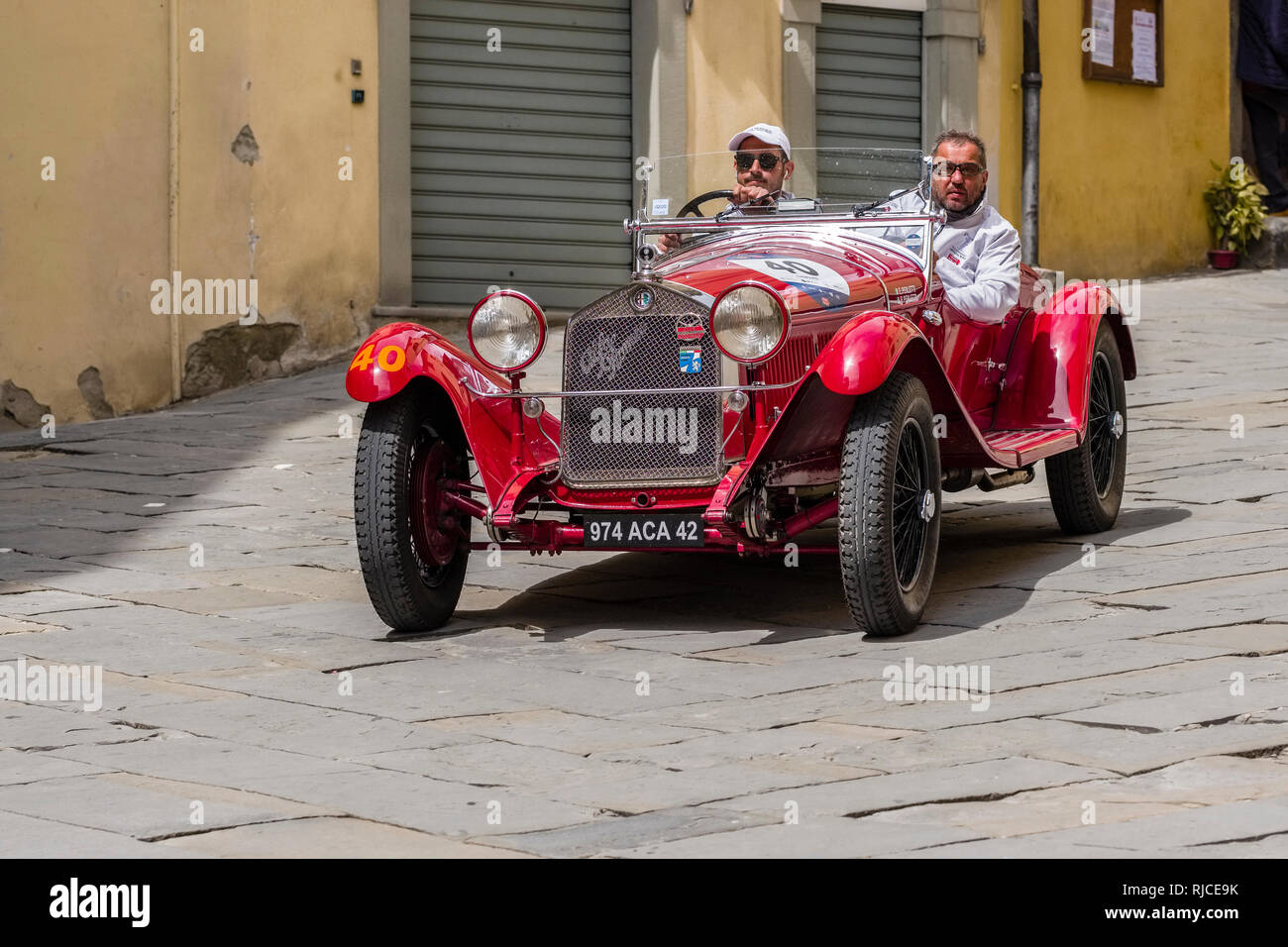 A vintage car, joining the rallye Mille Miglia, driving through the ...