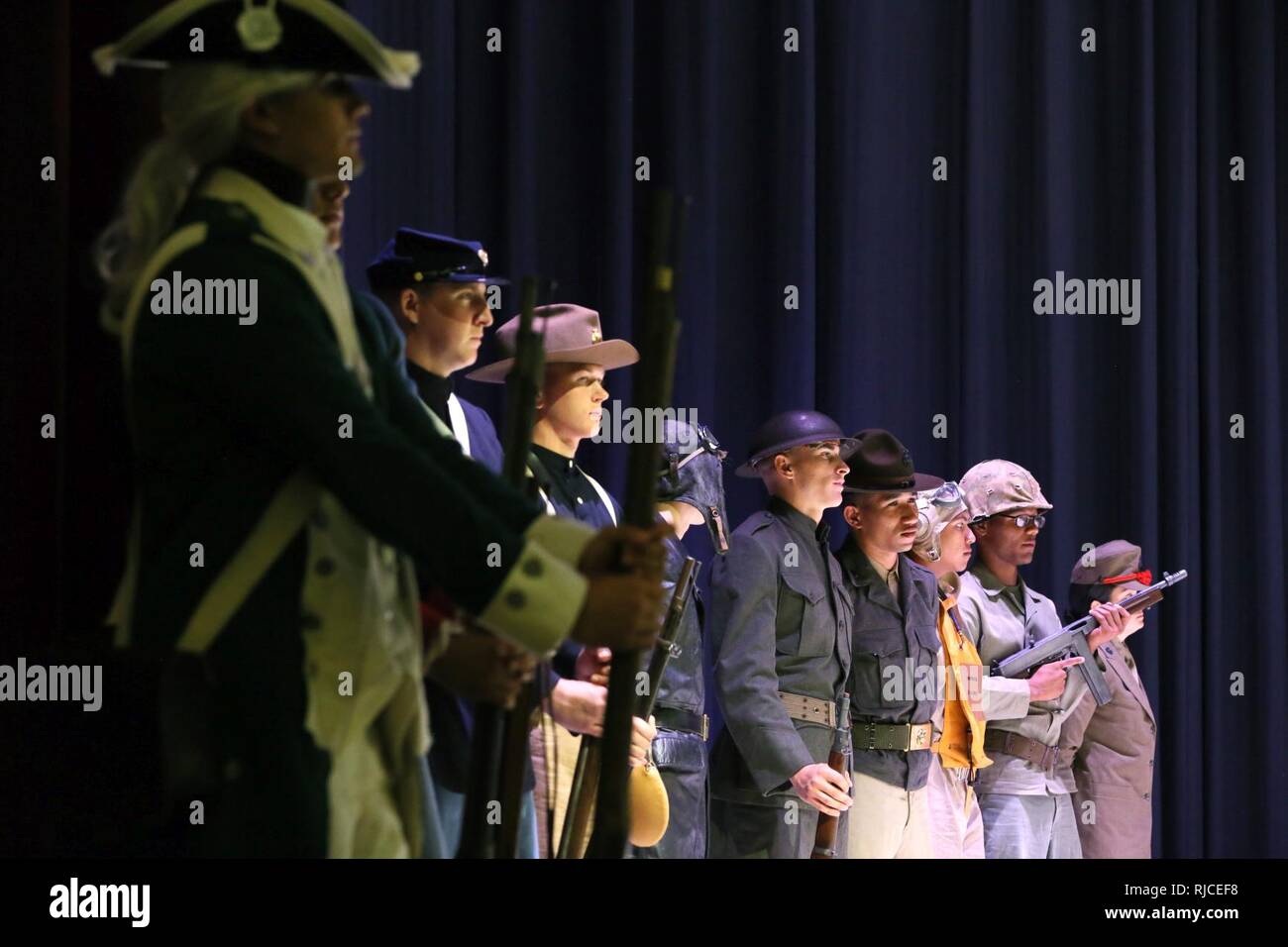 Marines representing the Marine Corps throughout the ages stand on the ...