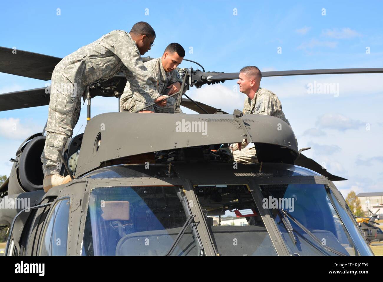 Chief Warrant Officer 2 Tom Henderson (right) asks questions as 2nd Lt ...