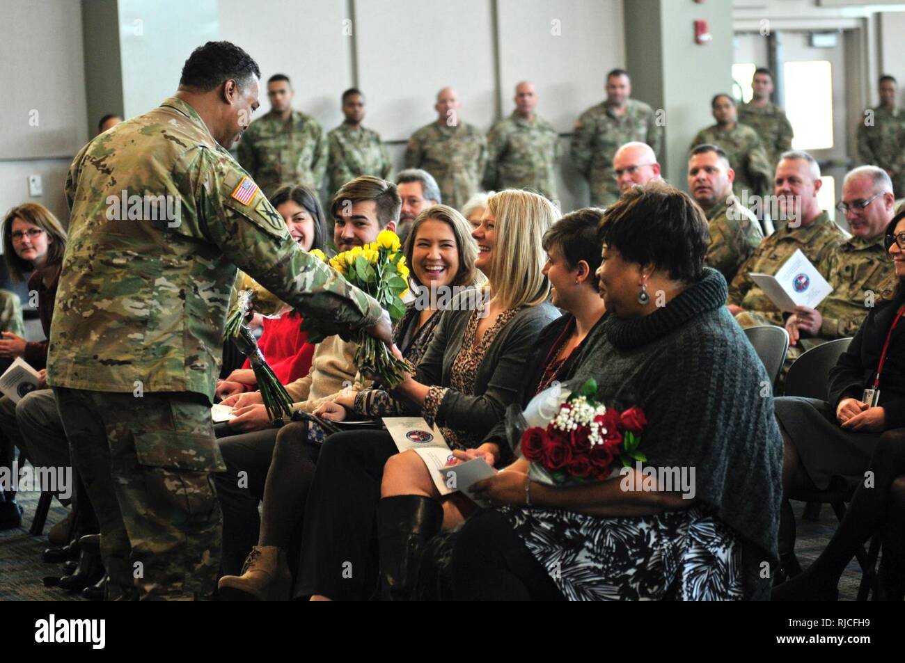 Flowers are presented to incoming Command Sergeant Major Shawn D. Lewis ...