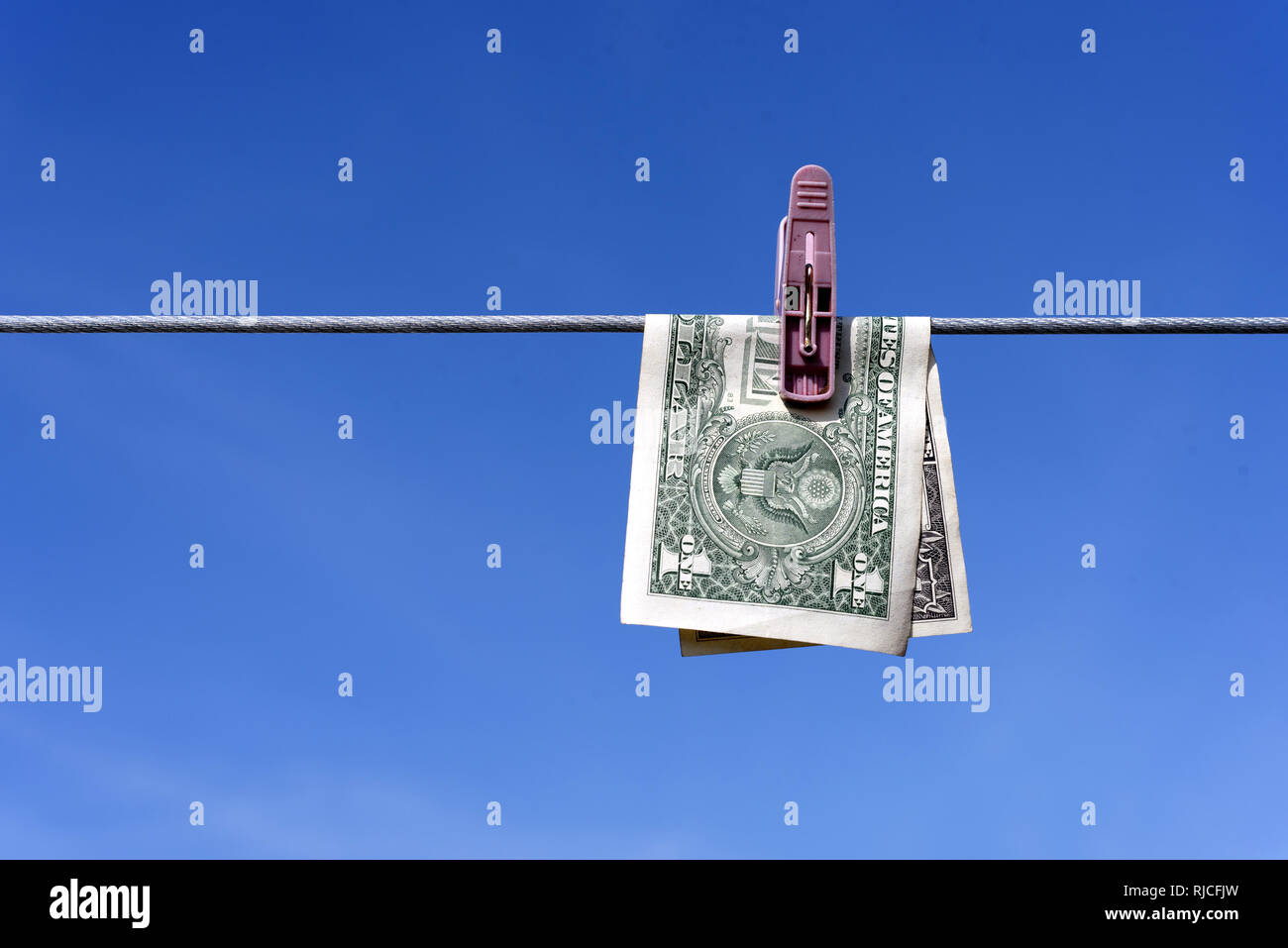 Money laundering of a one US Dollar bill note from the USA on a washing ...