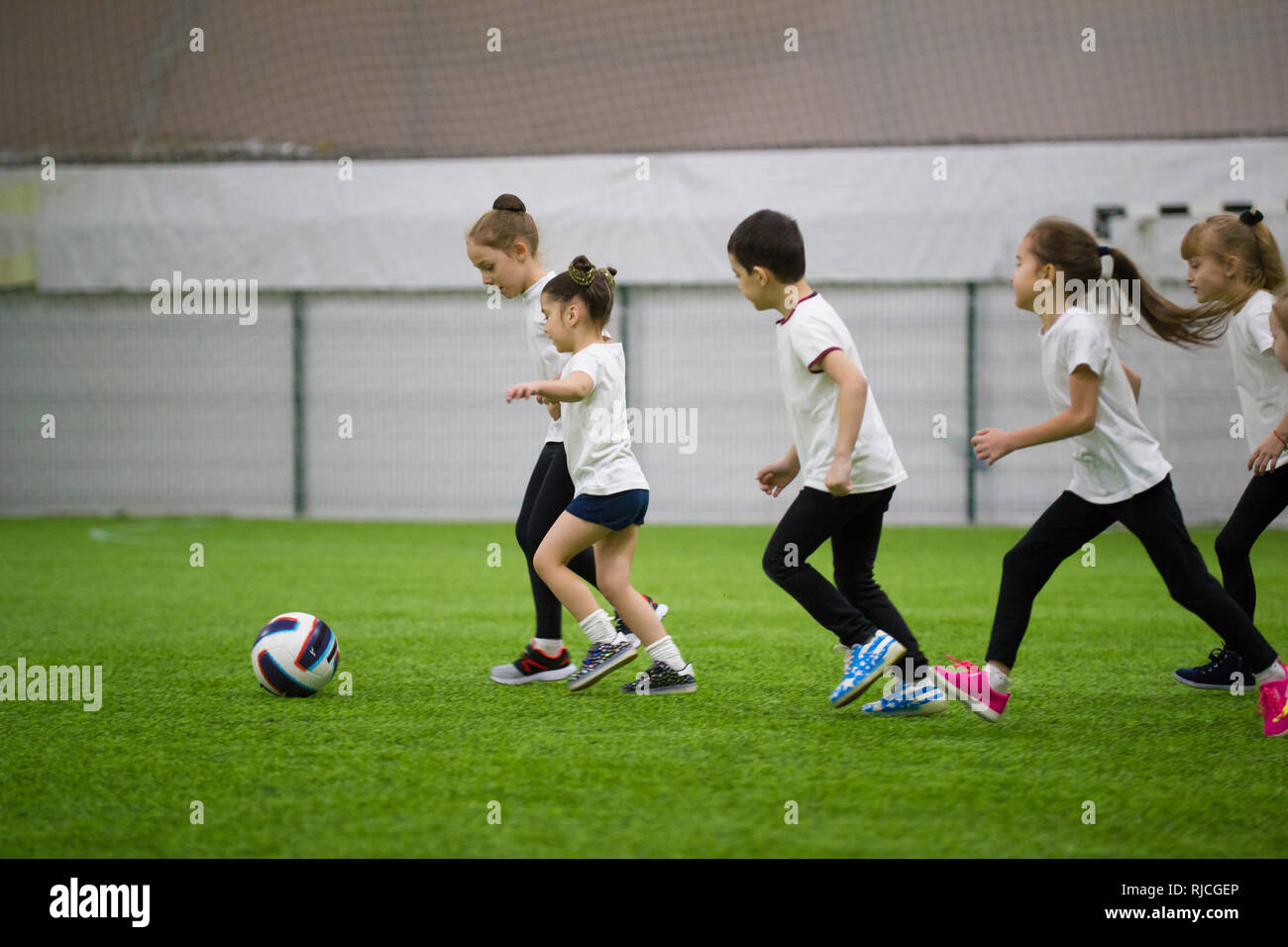 Kids playing soccer indoors hi-res stock photography and images - Alamy