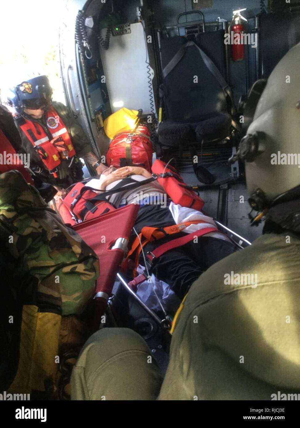 Coast Guard crewmembers aboard an MH-60 Jayhawk helicopter from Air ...