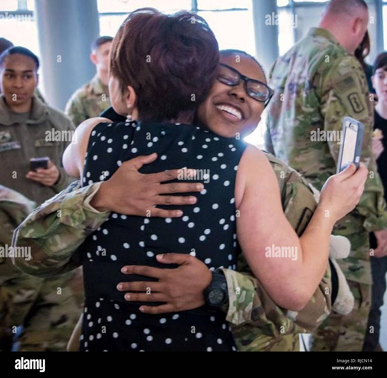 Capt. Melissa Coker embraces Megan Nunez during the redeployment ...