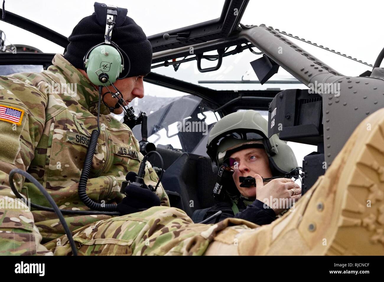 Chief Warrant Officer 3 Cole Sisson (left), an AH-64 Apache helicopter ...