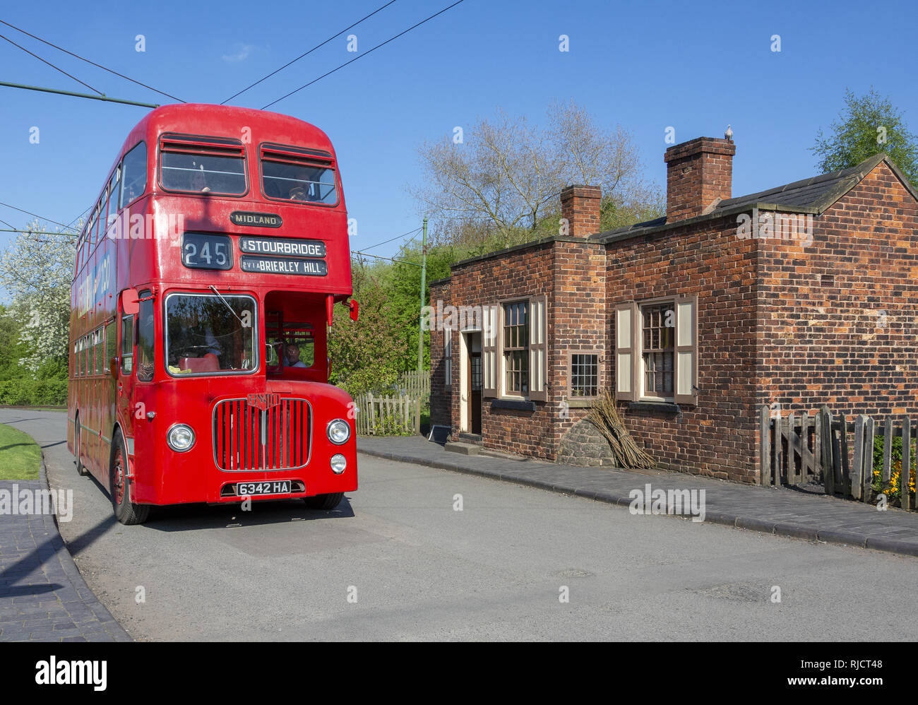 Red electric trolley bus passing the Woodsetton tollhouse at the Black ...