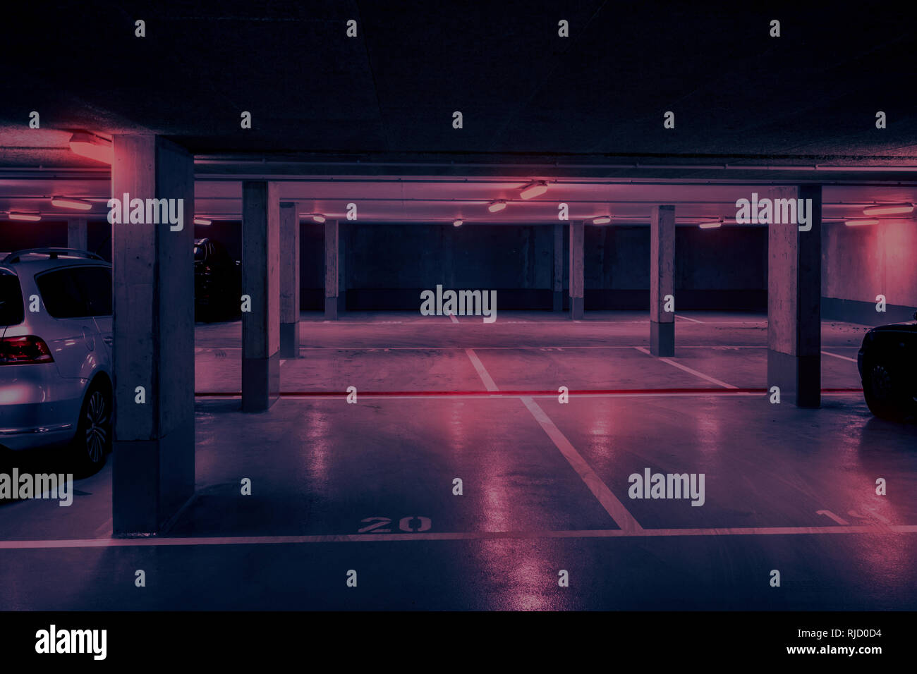dark underground car parking deck with neon red light Stock Photo - Alamy