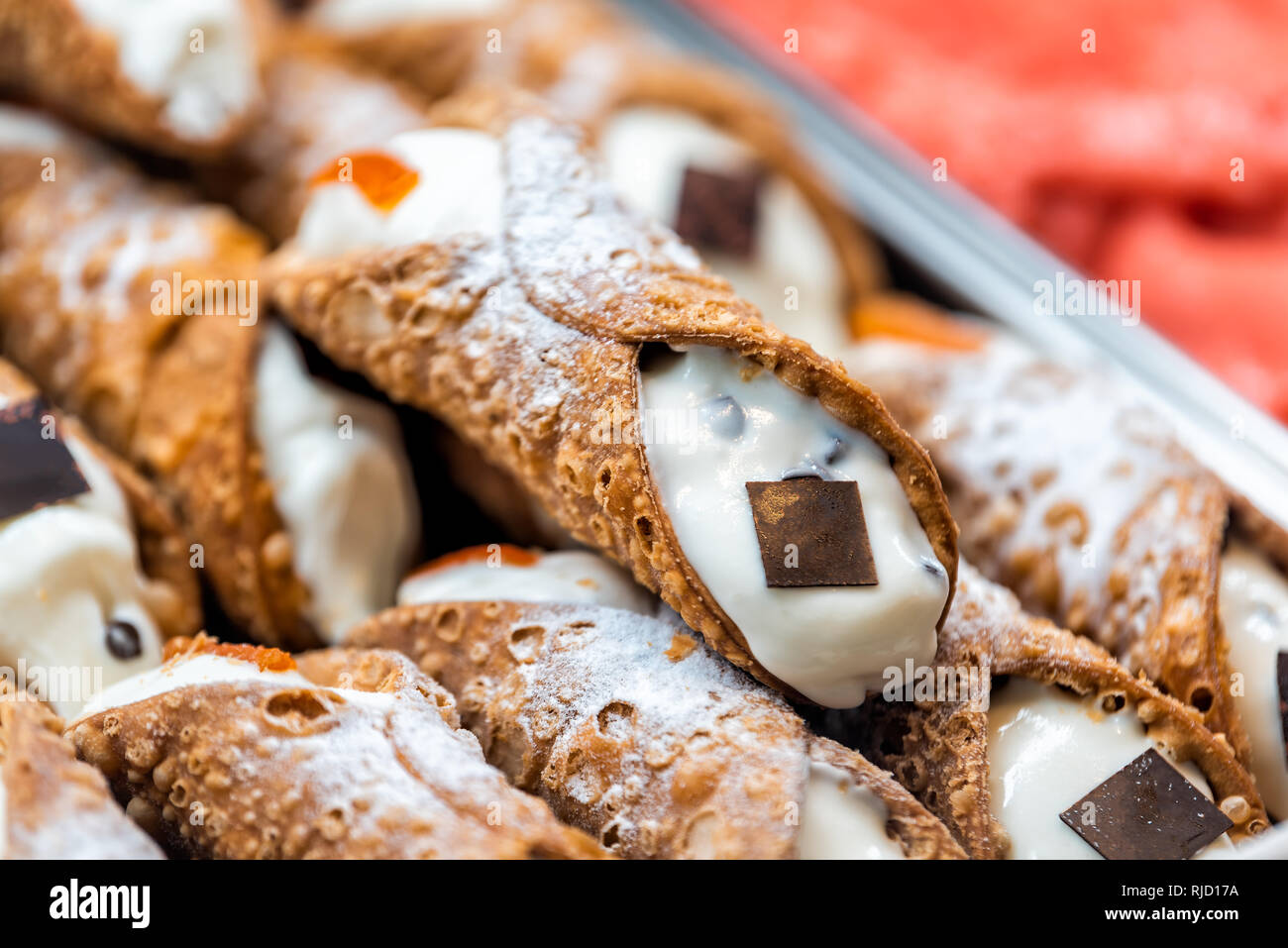 Closeup of chocolate cannoli stuffed with cream cheese filling dessert ...
