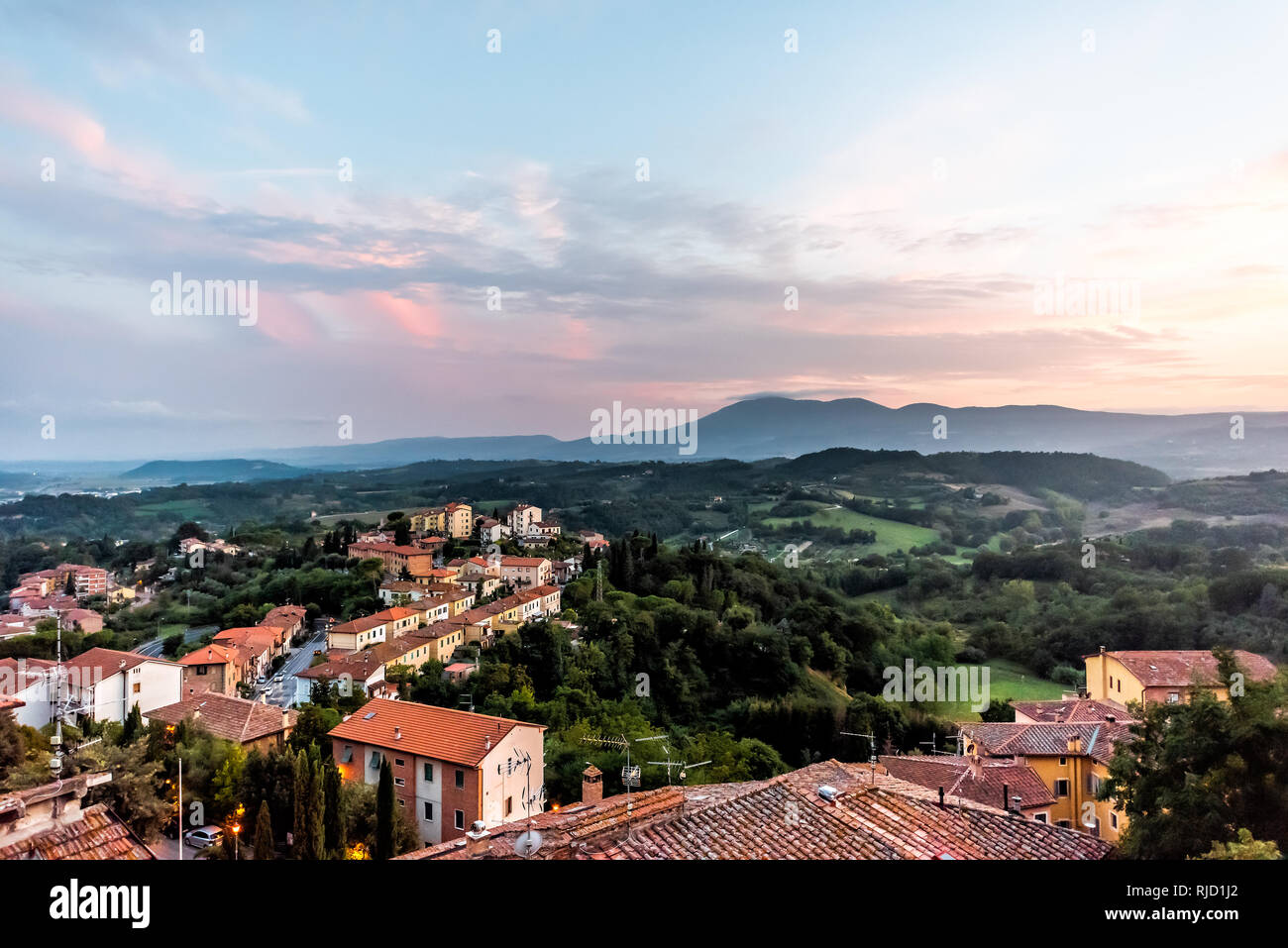 Chiusi sunset evening in Umbria, Italy with rooftop houses on mountain ...