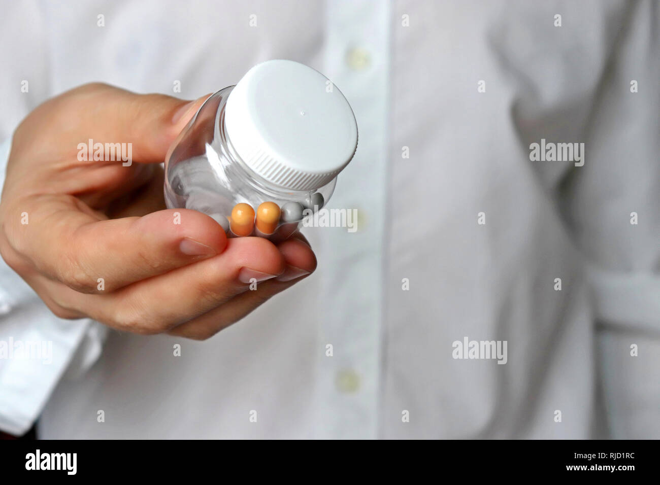 Doctor giving bottle with pills, medication in capsules. Concept of ...