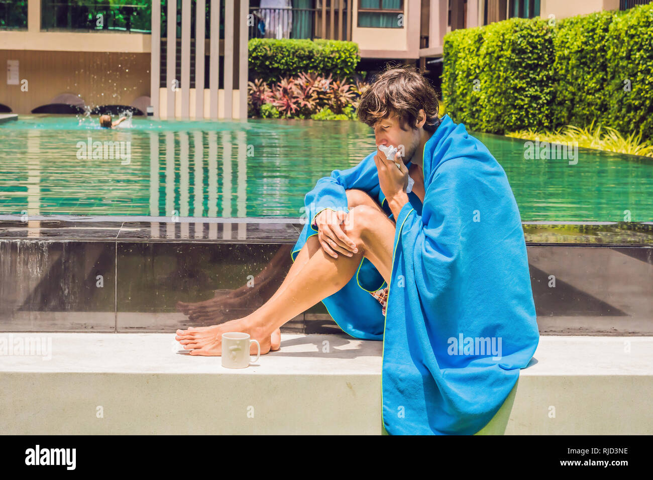 Sick man traveler. The man caught a cold on vacation, sits sad at the ...