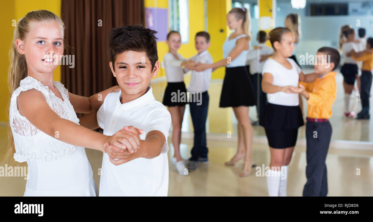Group of friendly children dancing tango in dance studio Stock Photo ...