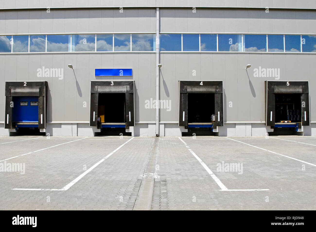 Several cargo door ramp at warehouse building Stock Photo - Alamy