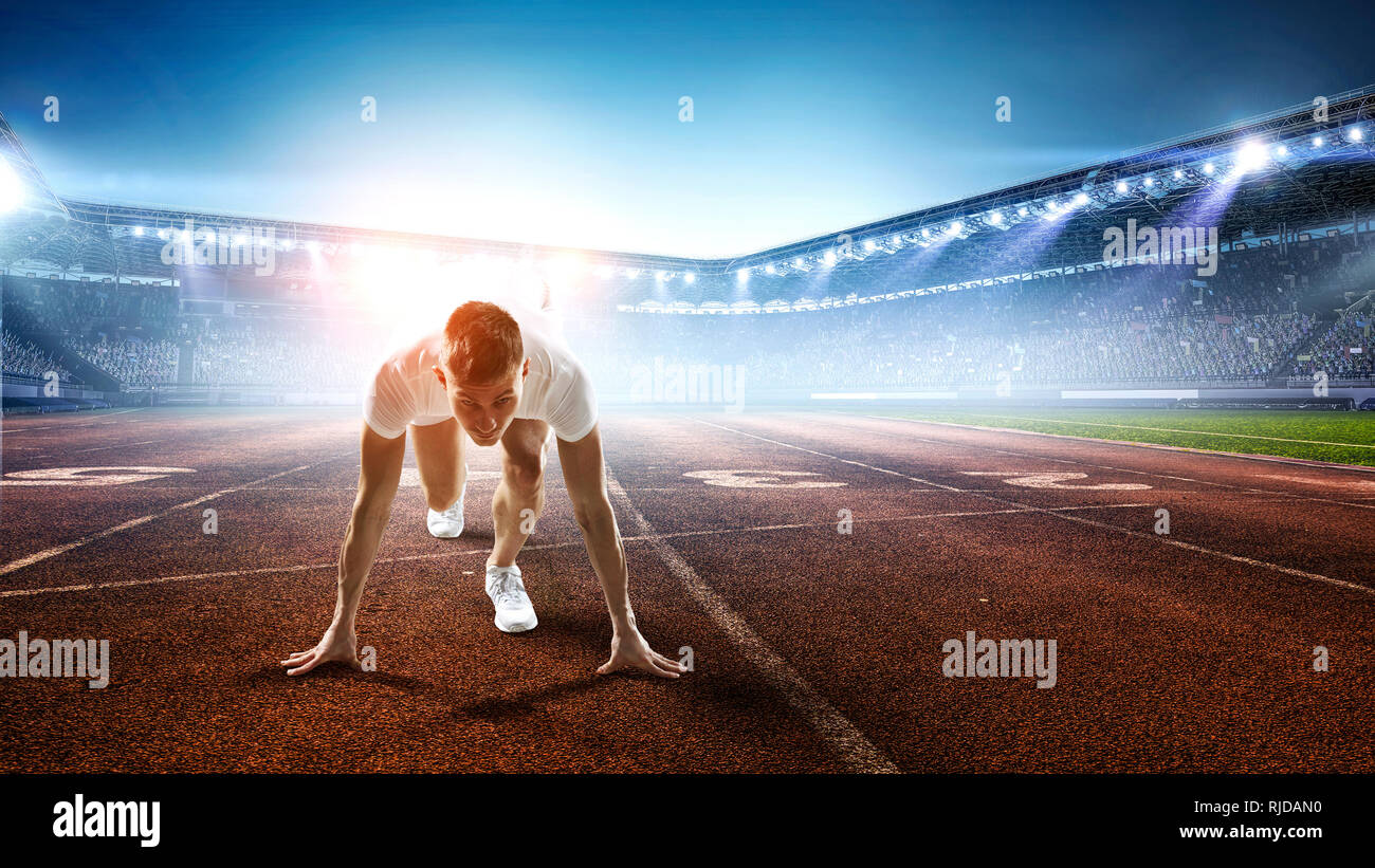 Athlete man running on racetrack at stadium. Mixed media Stock Photo ...