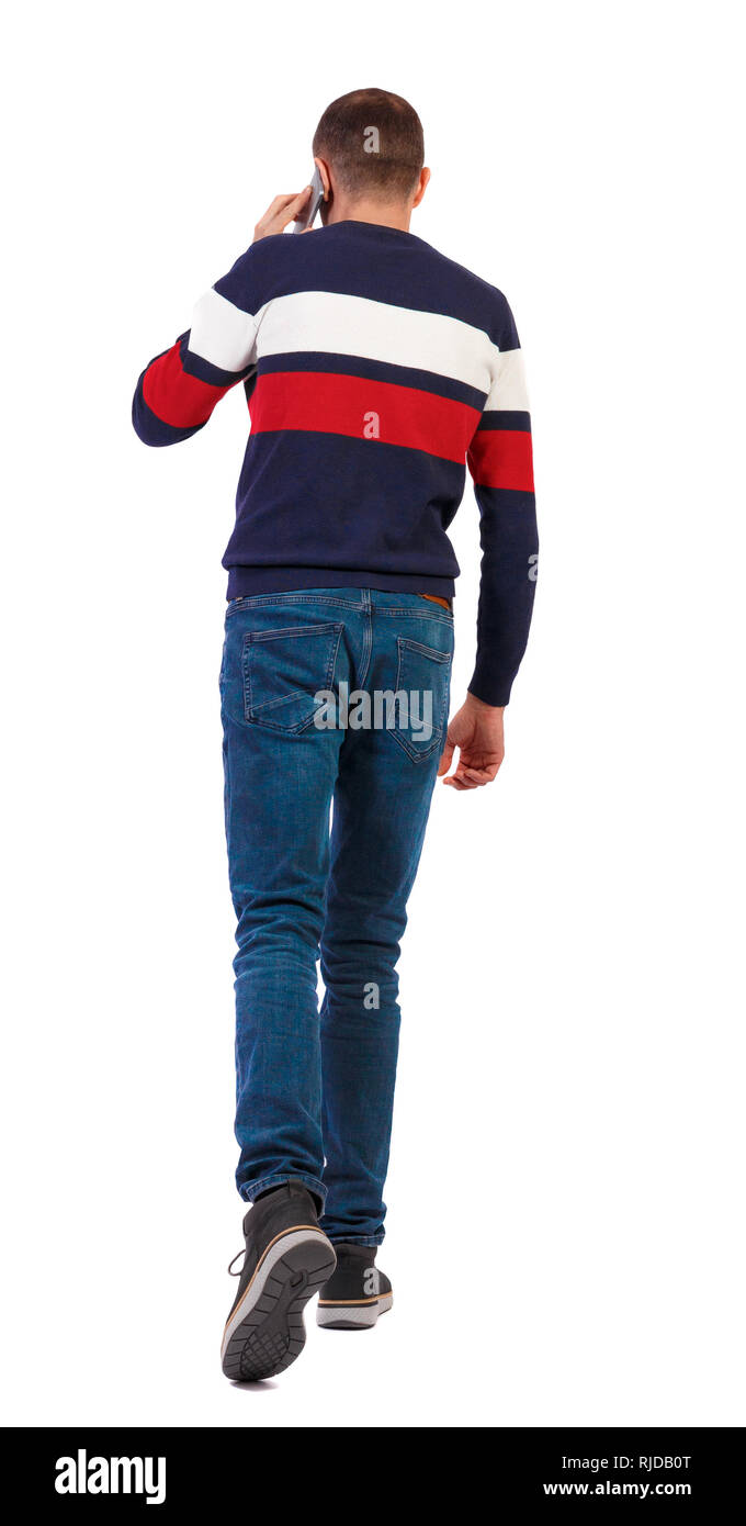 Back view of man walking with a mobile phone. backside view of person ...