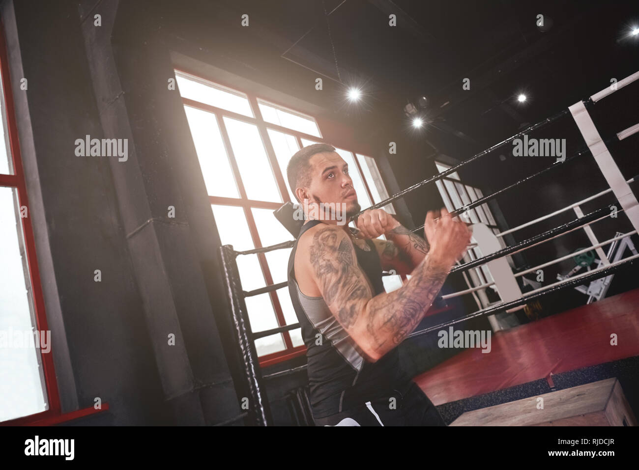 Muscular strong boxer mma fighter in sports clothing training power ...