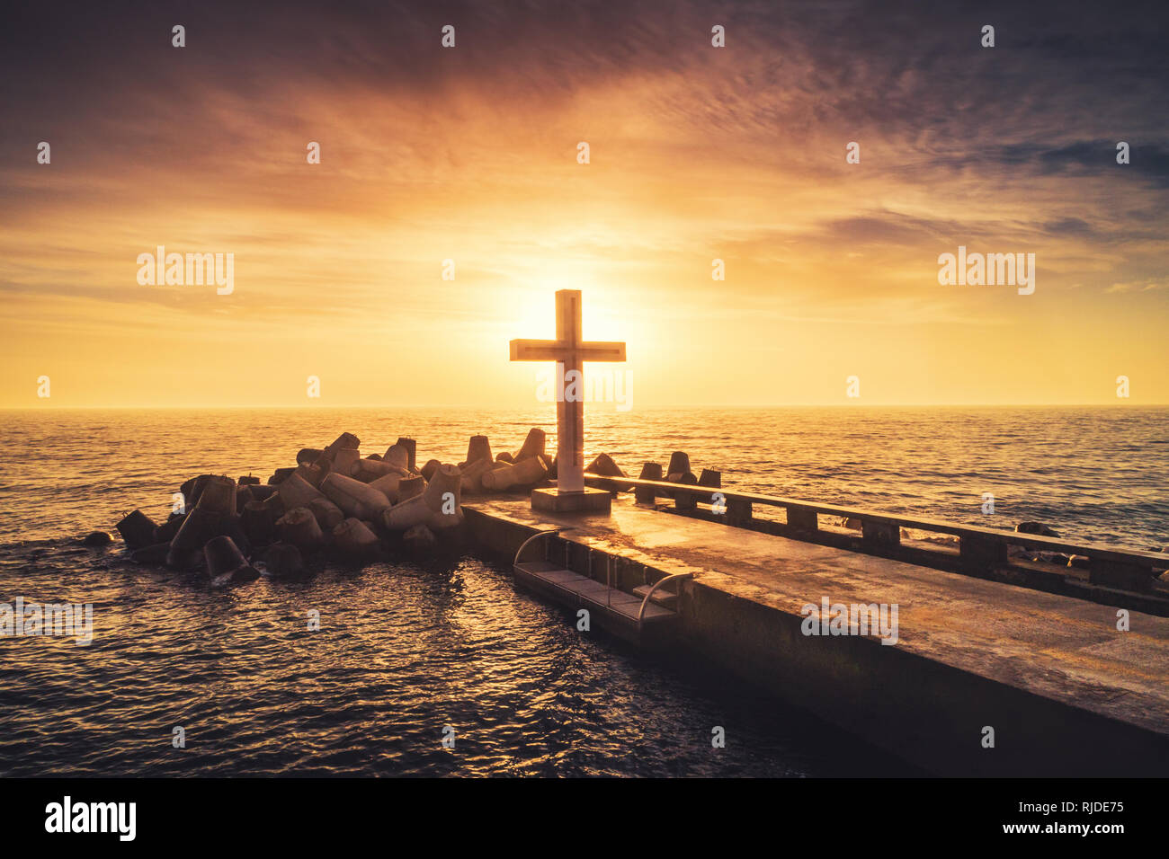 Aerial view over silhouette christian cross in the sea, sunrise shot ...