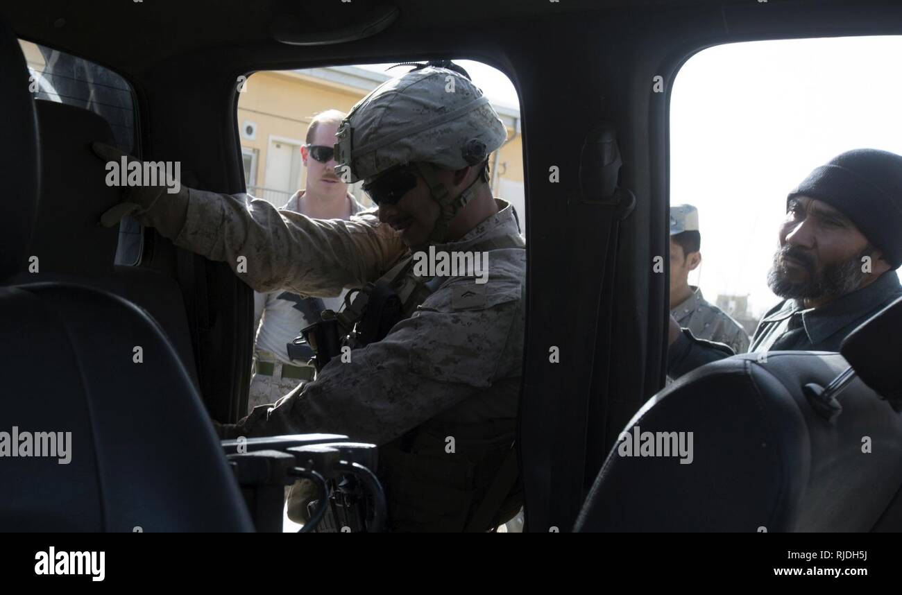 A U.S. Marine with Task Force Southwest demonstrates a vehicle search ...