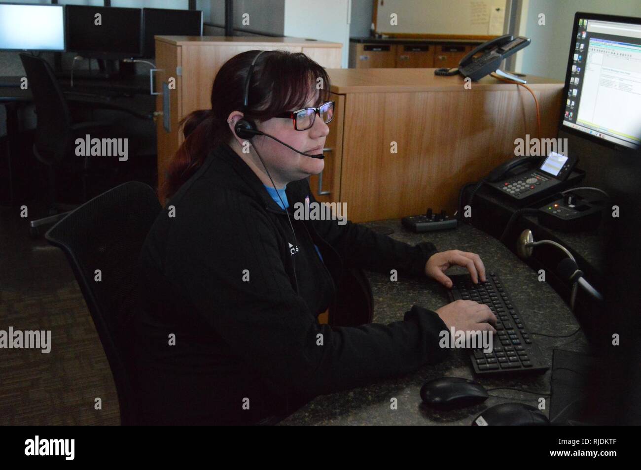 Rebecca Winans, Fort Carson Fire Department dispatcher, answers a 911 ...