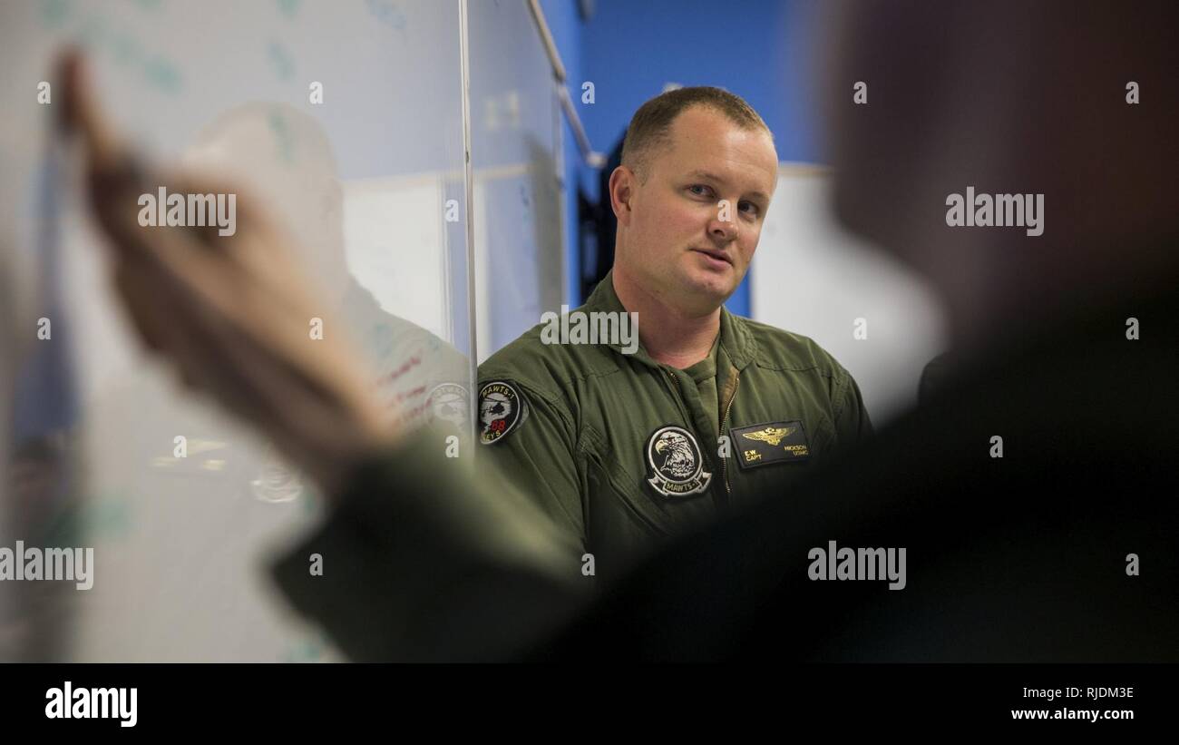 U.S. Marine Corps Capt Erik Hickson leads a meeting during a planning ...