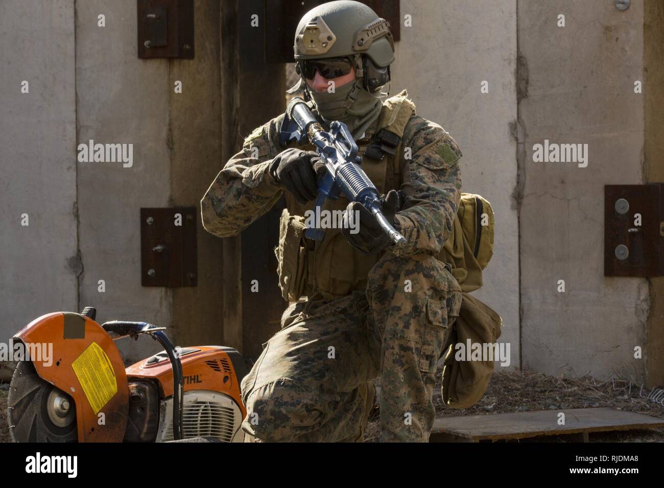A U.S. Marine attending the Methods of Entry (MOE) provides security ...