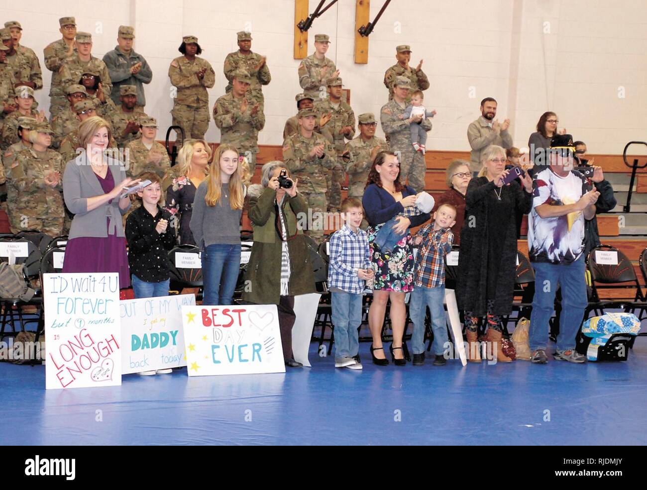 Family members applaud the arrival of their Soldiers during a ...