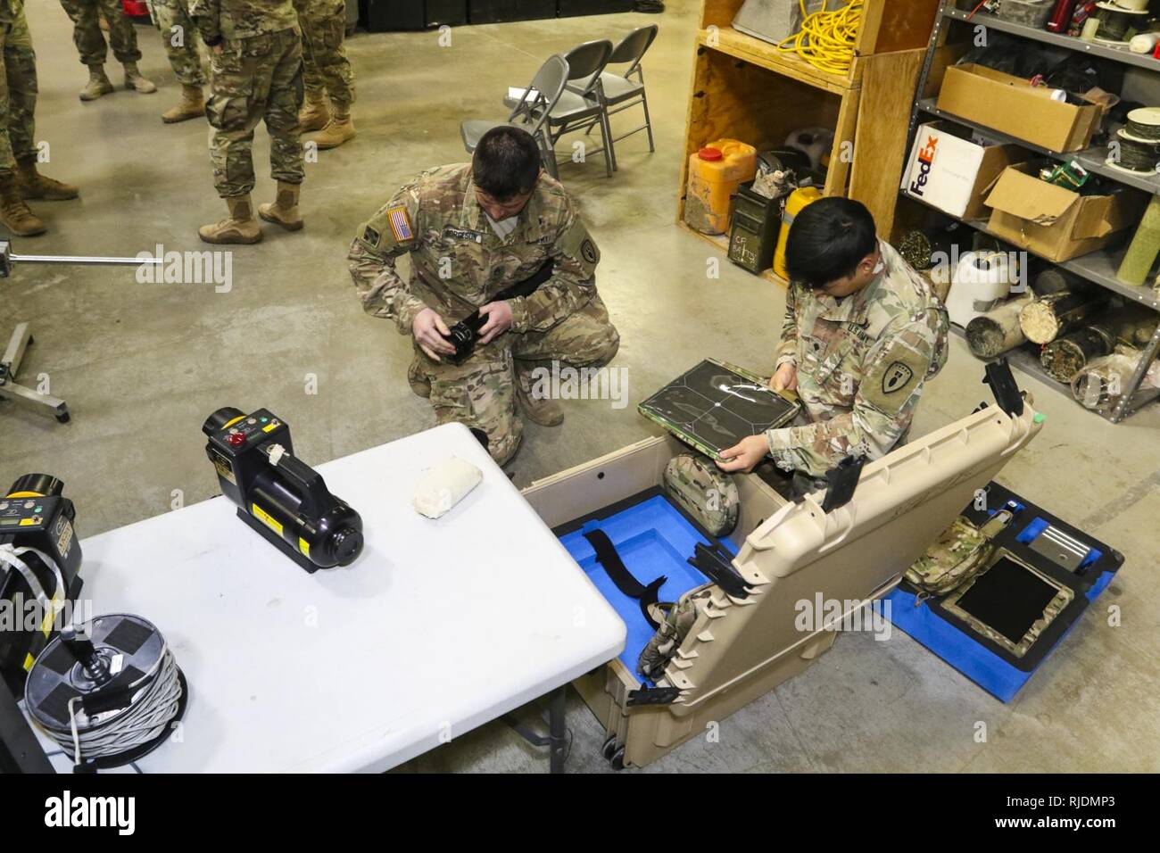 (From left) Staff Sgt. David Borgeson, team leader, and Spc. Lee Yoon ...