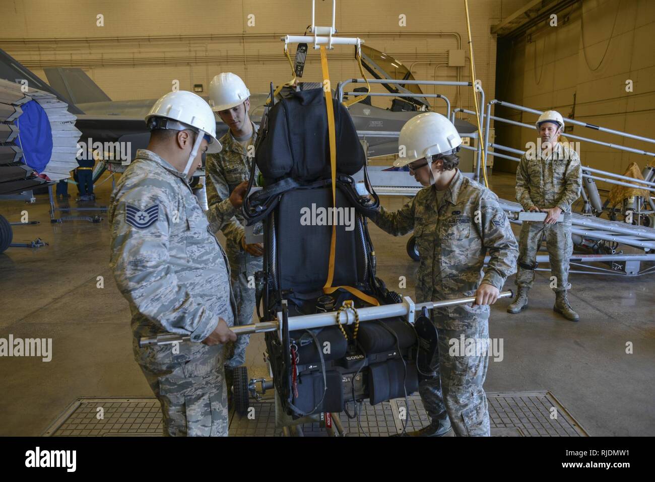 Airmen assigned to the 56th Component Maintenance Squadron guide an F ...