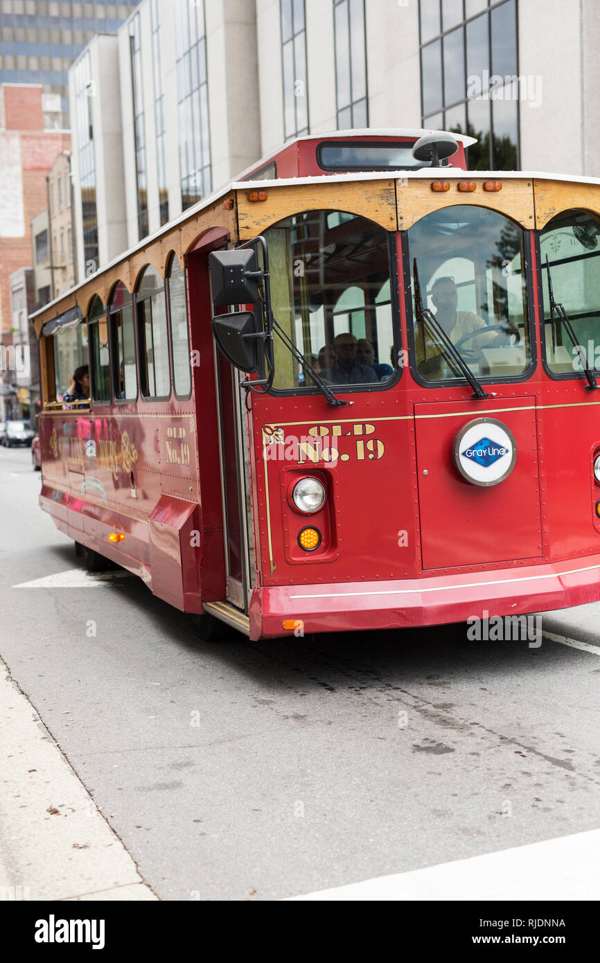 A trolley drives through historic downtown Asheville, North Carolina ...