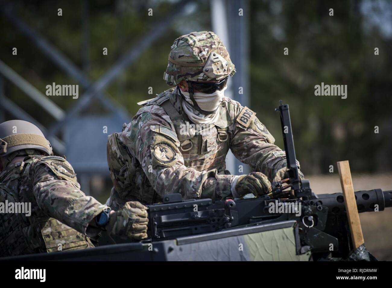An Airman from the 824th Base Defense Squadron loads a M2 machine gun ...