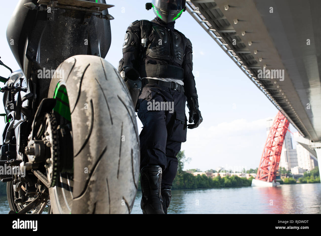 Biker man and motorcycle with river background, Rider moto trip on the ...
