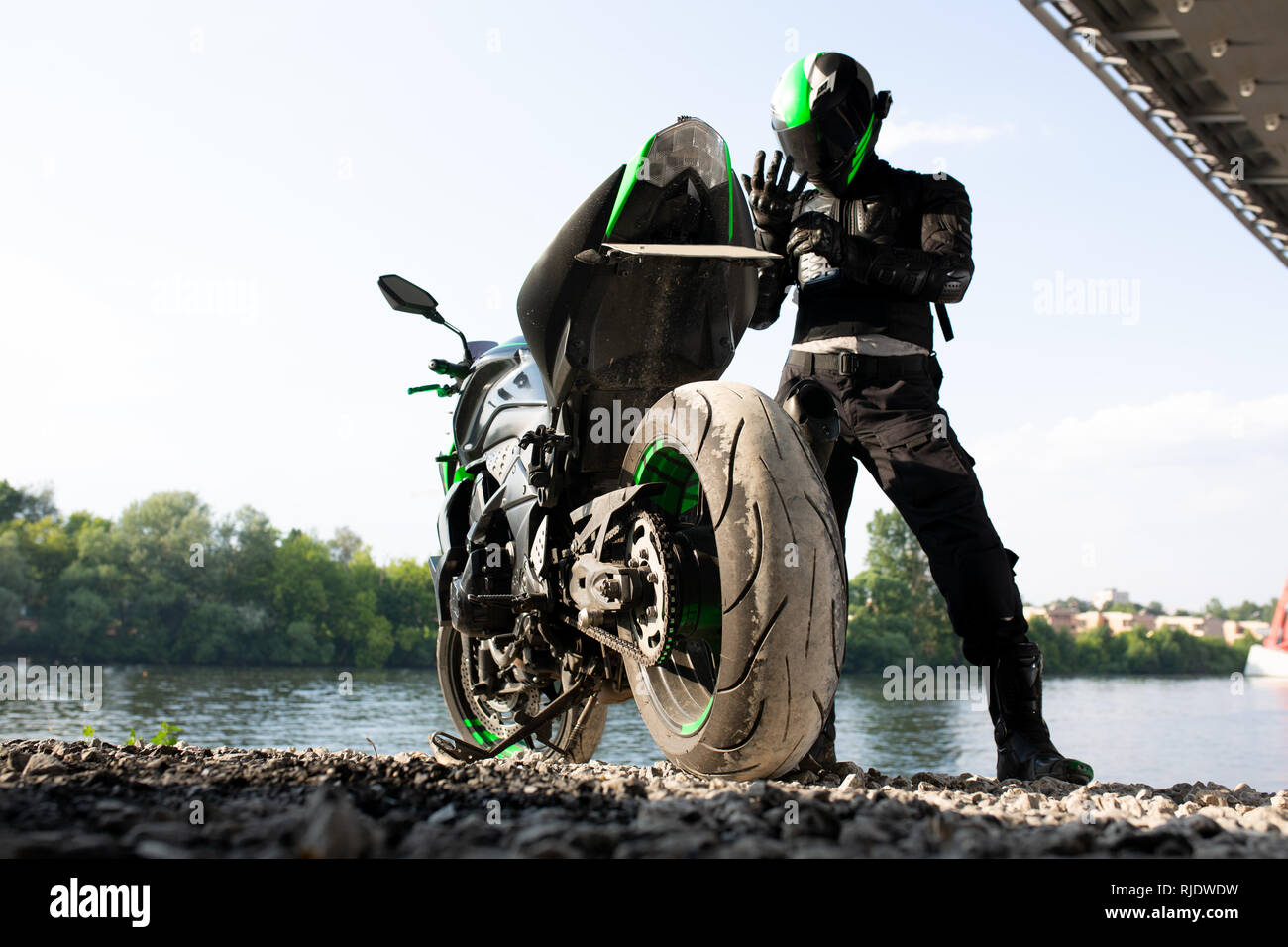 Biker man and motorcycle with river background, Rider moto trip on the ...