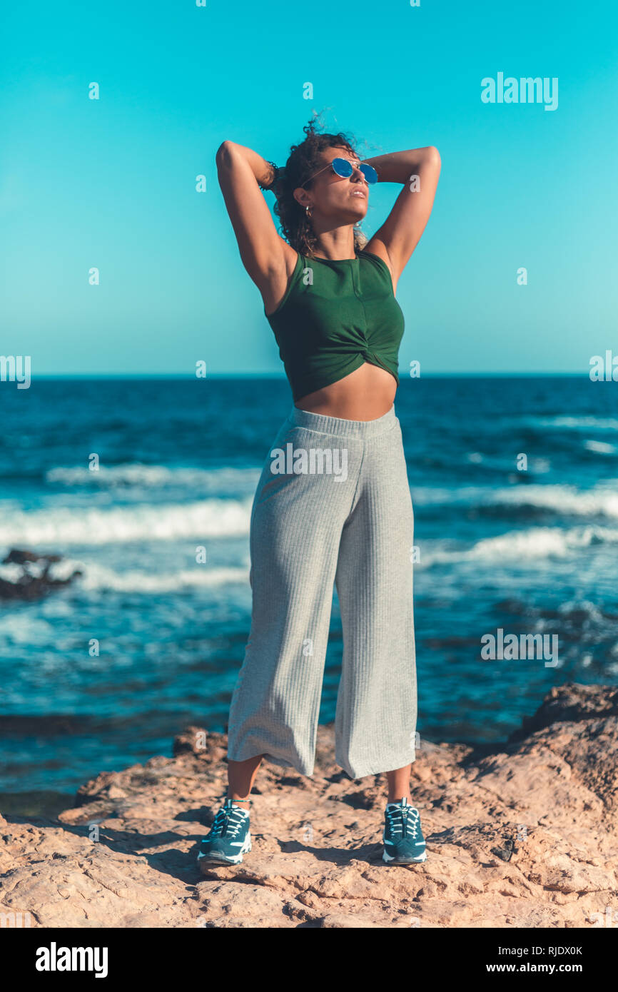 Stylish Woman standing near sea Stock Photo - Alamy