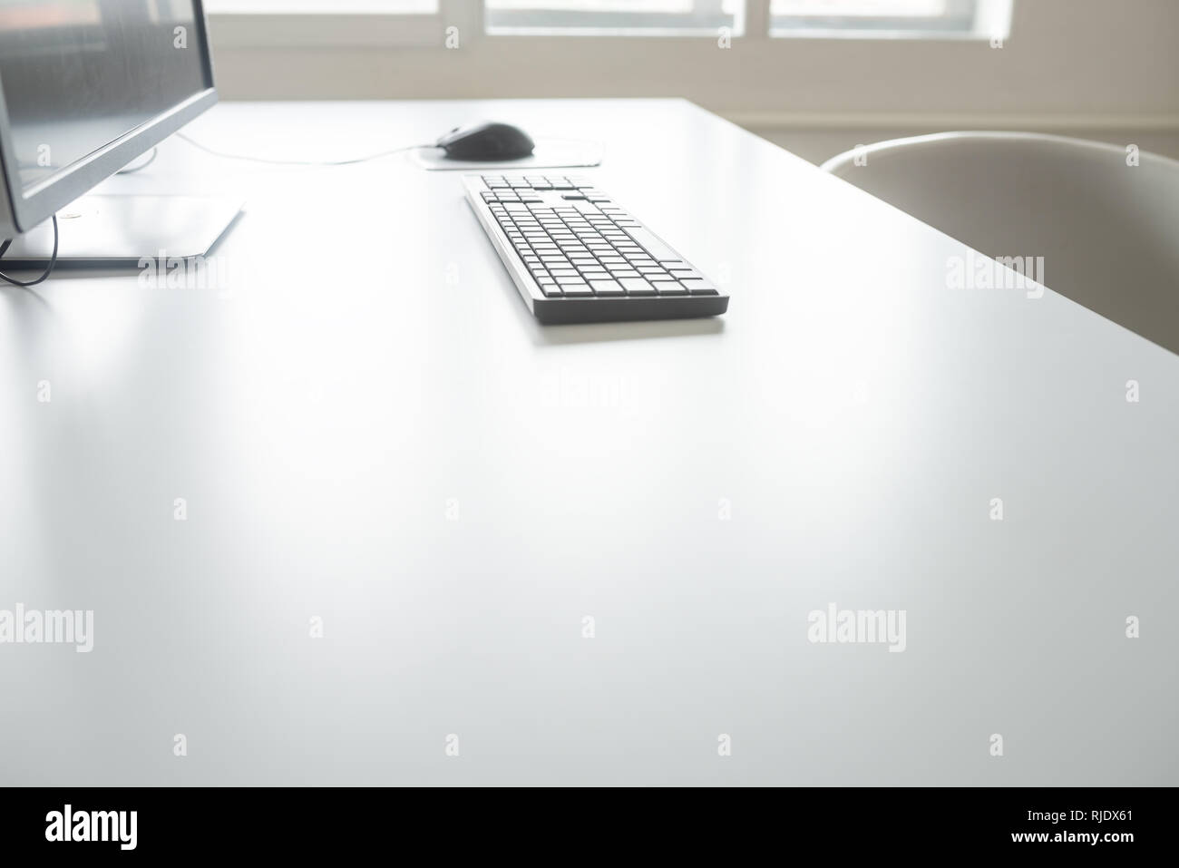 Low angle view of office computer - monitor, mouse and keyboard, on a ...