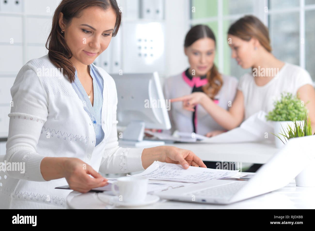 Portrait of young women working in modern office Stock Photo - Alamy