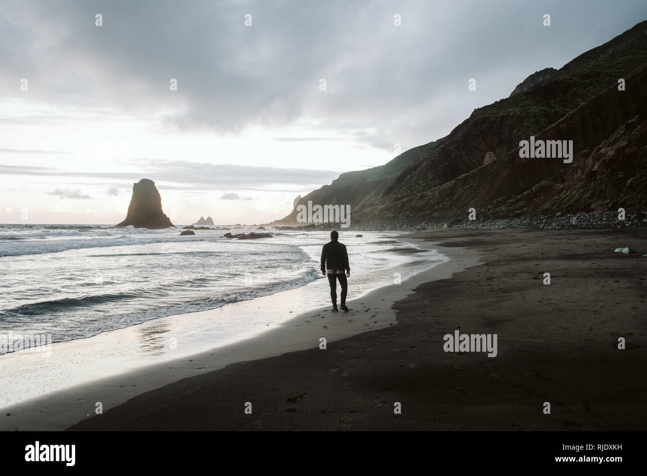 Anonymous man standing near sea Stock Photo - Alamy