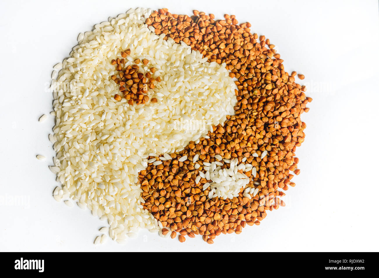 The symbol of yin yang is laid out of buckwheat and rice, texture. 2019 ...