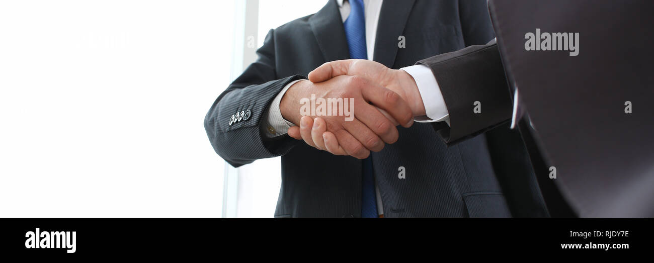 Man in suit shake hand as hello in office Stock Photo - Alamy