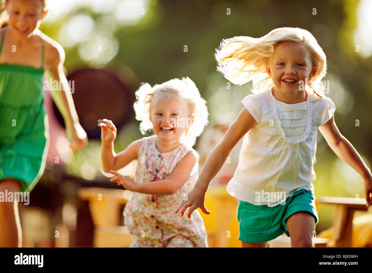 Happy siblings playing in their backyard Stock Photo - Alamy