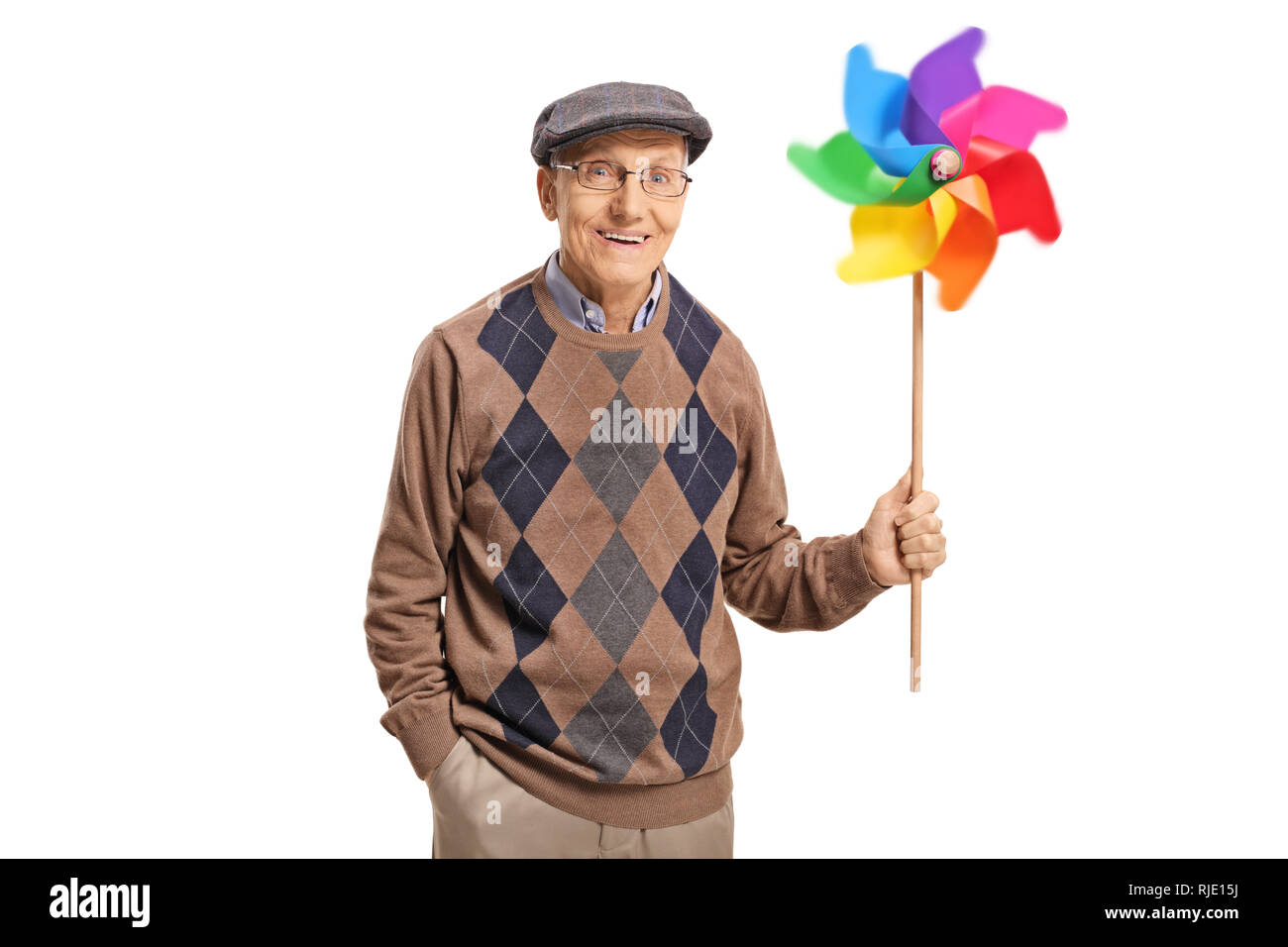 Cheerful elderly man holding a spinning colorful pinwheel isolated on ...