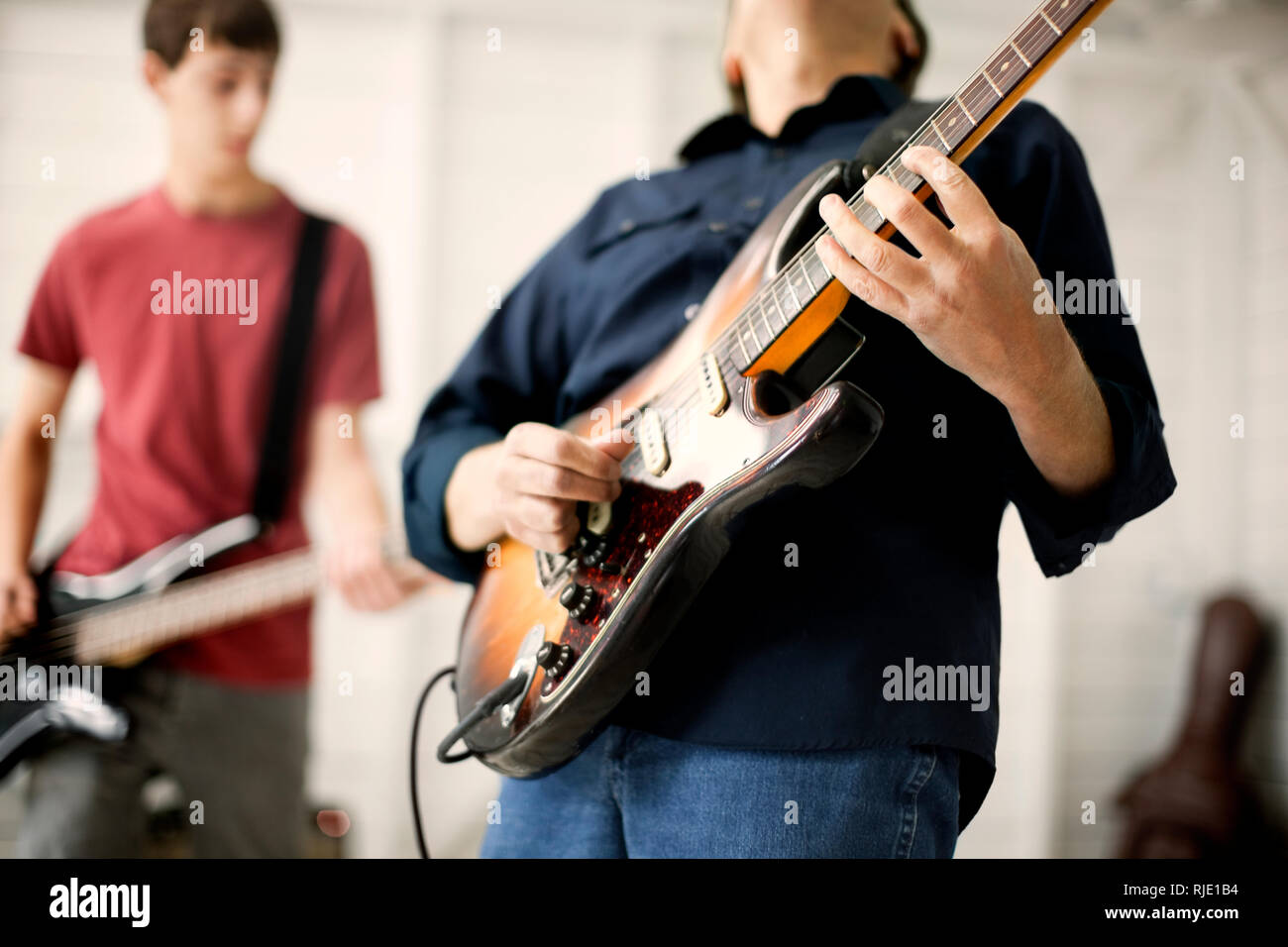 Children playing electric guitar hi-res stock photography and images ...