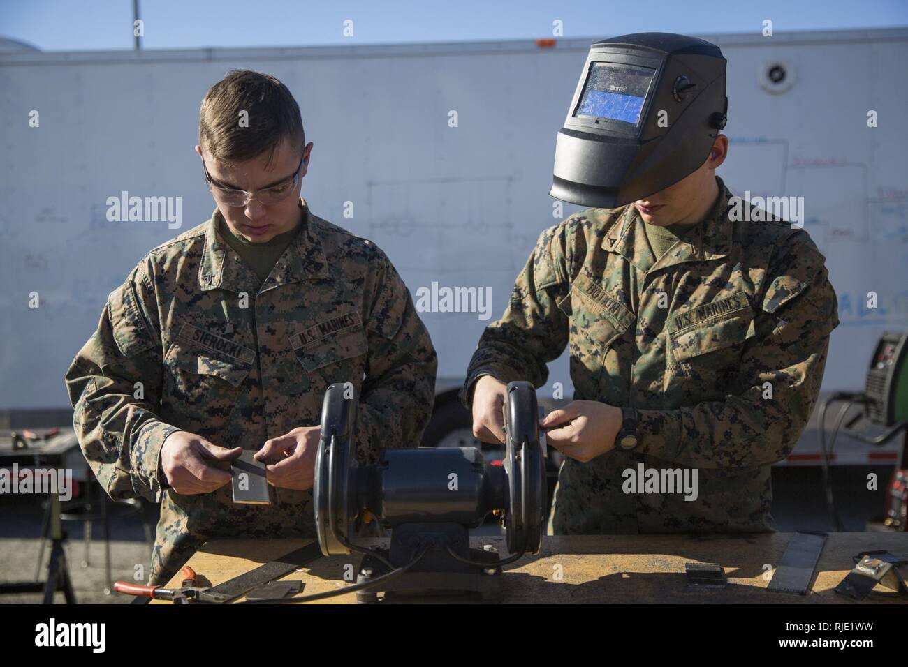 Cpl. Abe Sierocki, left, and Lance Cpl. Landon Botkin, right, grind ...