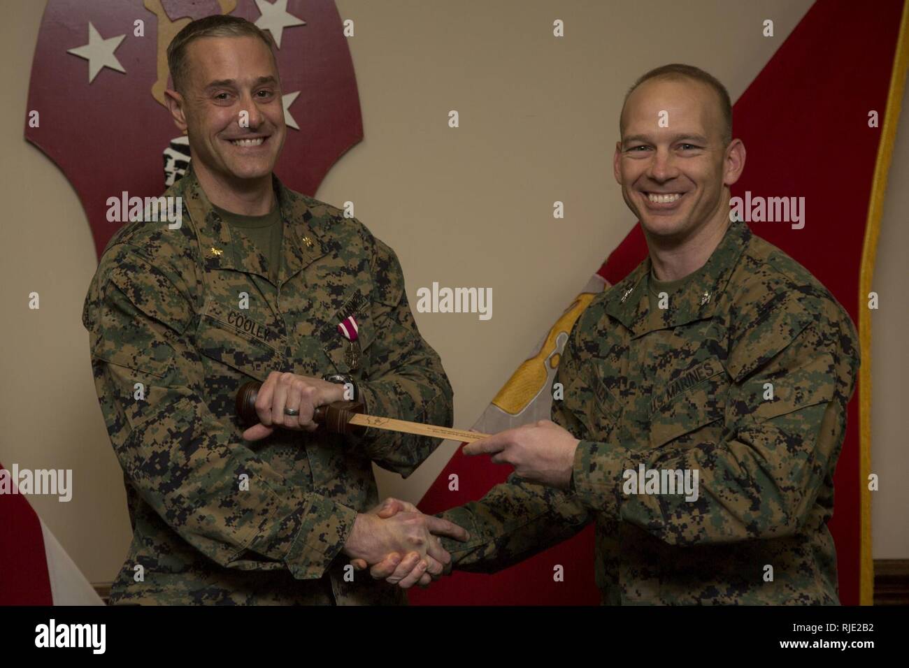 U.S. Marine Corps Maj. Jody L. Cooley, left, receives a gift from Col ...