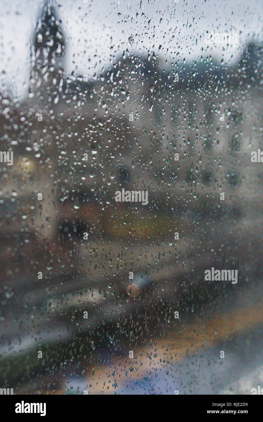 City view behind rain covered window Stock Photo - Alamy