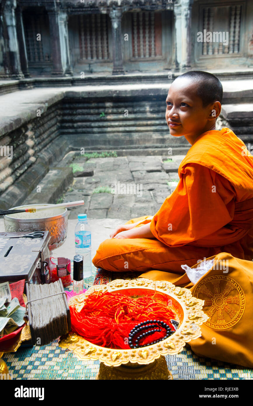 Monk in a saffron robe at the Angkor Wat temple complex in Cambodia ...