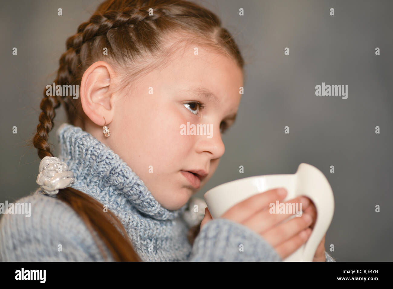 cute sick girl with cup of rea Stock Photo - Alamy
