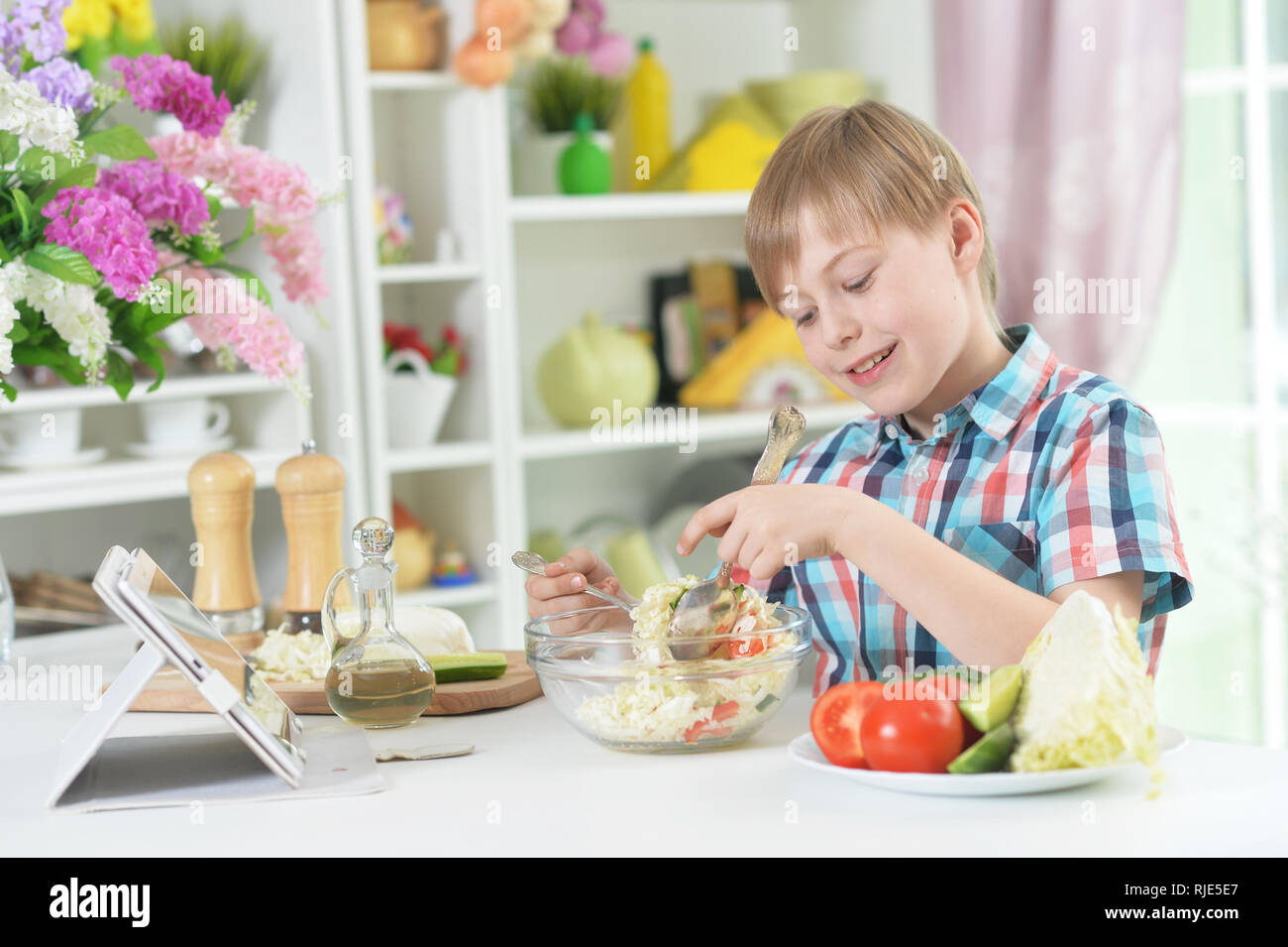 Portrait of cute little boy making dinner Stock Photo - Alamy