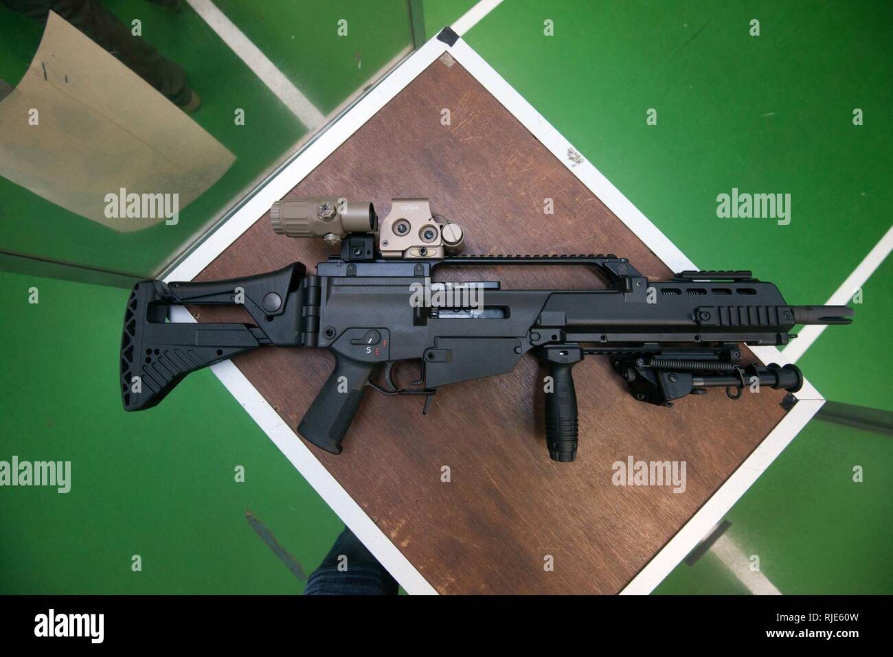 A Heckler and Koch G36K A4 rifle with holographic sight lays on a table ...